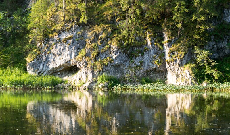 Calm River and Rock Bank stock photo. Image of flowing - 56714248