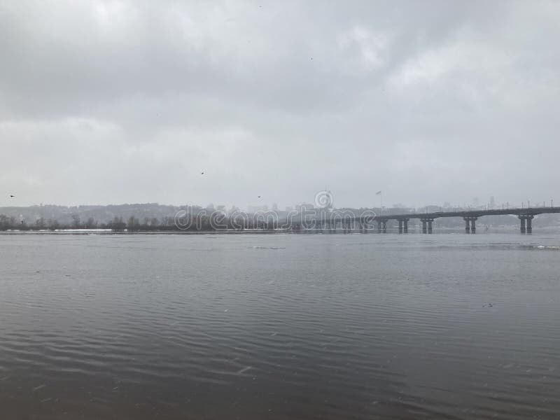 A Calm River Scene with Two Distant Bridges, Surrounded by Vegetation ...
