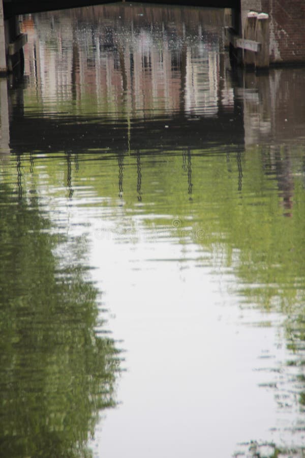 Calm River Water with the Reflection of the Buildings Stock Photo ...
