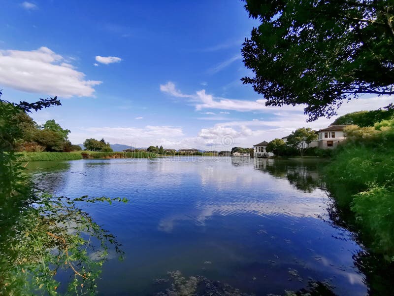 Calm Scenery of a Lake with the Reflection of Trees and Sky on the ...
