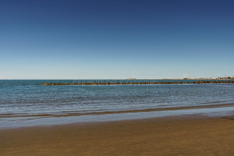 Calm Sea Overlooking a Smooth Sandy Beach Stock Photo - Image of ...