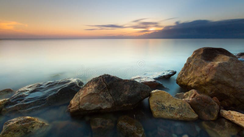 Calm sea at sunset. stock photo. Image of natural, exposure - 129310210