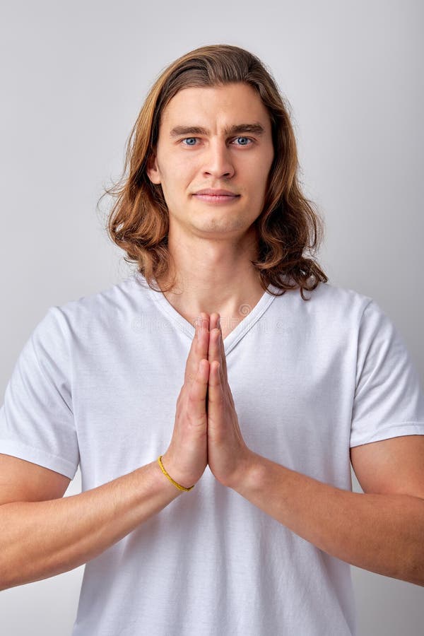 Calm Spiritual Handsome Guy Praying, Looking at Camera. Serious ... Calm Spiritual Handsome Guy Praying, Looking at Camera. Serious ...