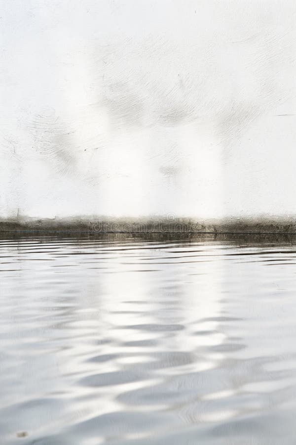 Water Reflection on Gray Wall. Calm Surface Mirrors Blue Sky Above ...