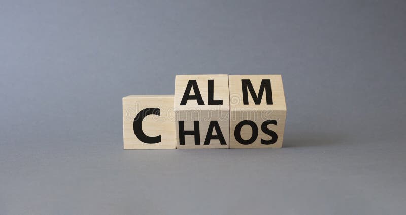 Calm Vs Chaos Symbol. Businessman Hand Points at Turned Wooden Cubes ... Calm Vs Chaos Symbol. Businessman Hand Points at Turned Wooden Cubes ...