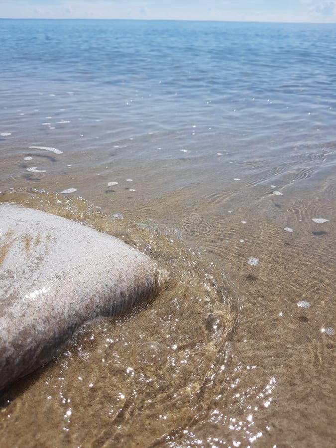 Calm water on the beach stock image. Image of calm, wall - 191470427