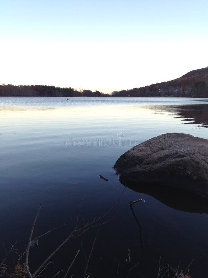 Calm water stock image. Image of lake, water, rock, sunny - 70208695