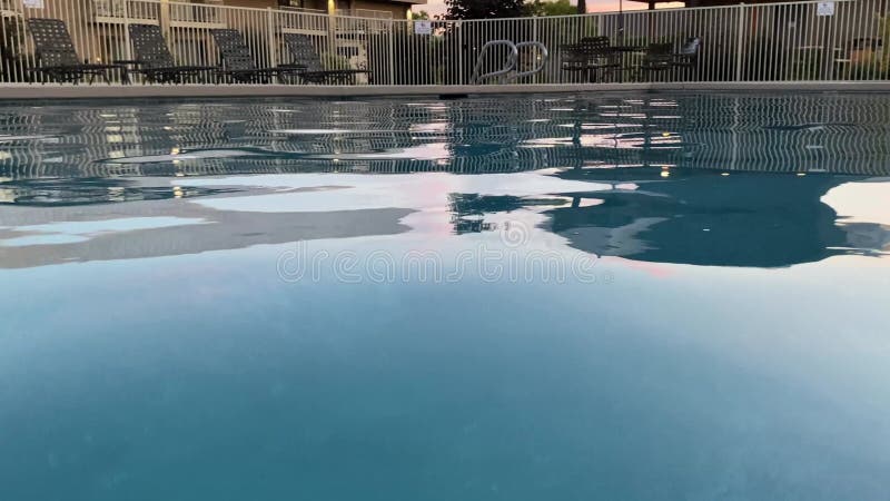 Calm Water Ripples Softly at a Hotel Pool at Sunset Stock Footage ...