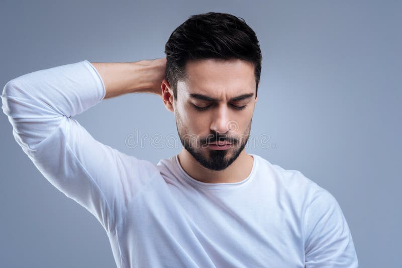 Calm Young Man Scratching His Head while Standing and Thinking Stock ...