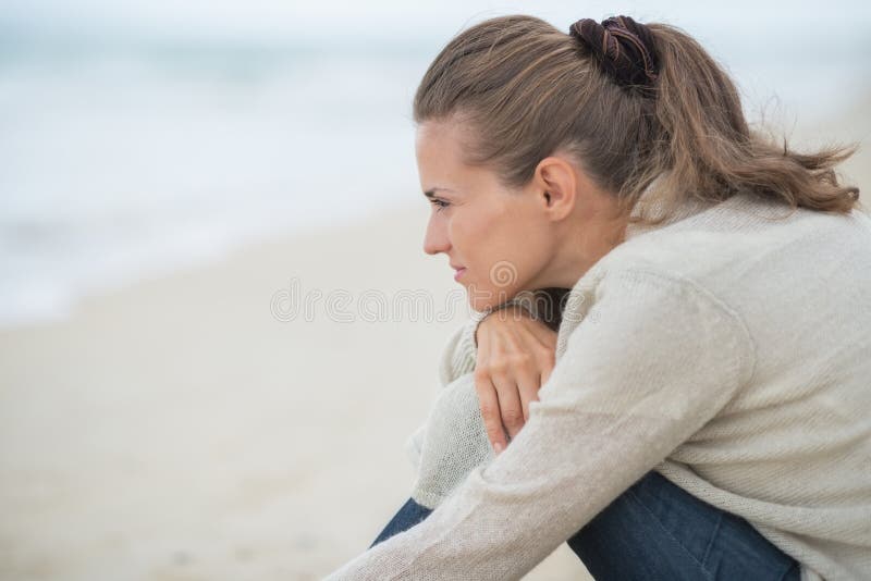 Calm Young Woman Sitting on Cold Beach Stock Photo - Image of relax ...