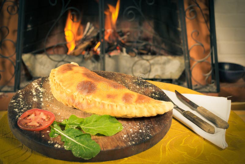 Calzone entering the oven stock photo. Image of background - 37134242