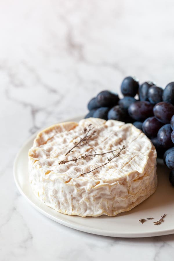 Camambert French Soft Cheese Served with Grapes, Decorated with Thyme ...
