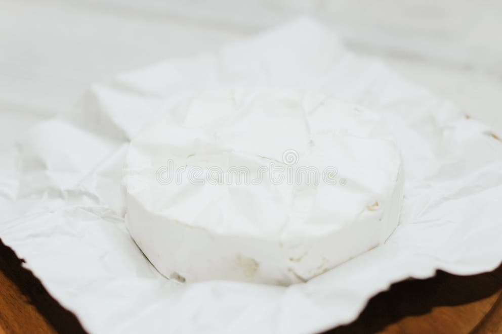 Camembert Cheese Unwrapped from Packaging on the Table. Stock Image ...