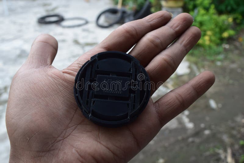 A camera cover of lens stock photo. Image of hand, black - 265226552