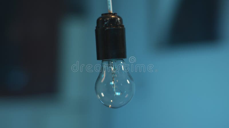 Camera is Dynamically Rotating Around One Blinking Bulb Light Hanging ...