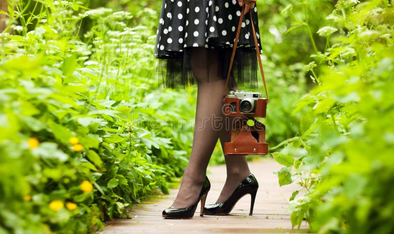 Camera and female legs stock photo. Image of photographer - 95361464