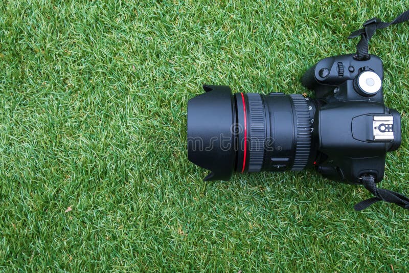 Camera on a Grass Background Stock Photo - Image of view, dslr: 73694070
