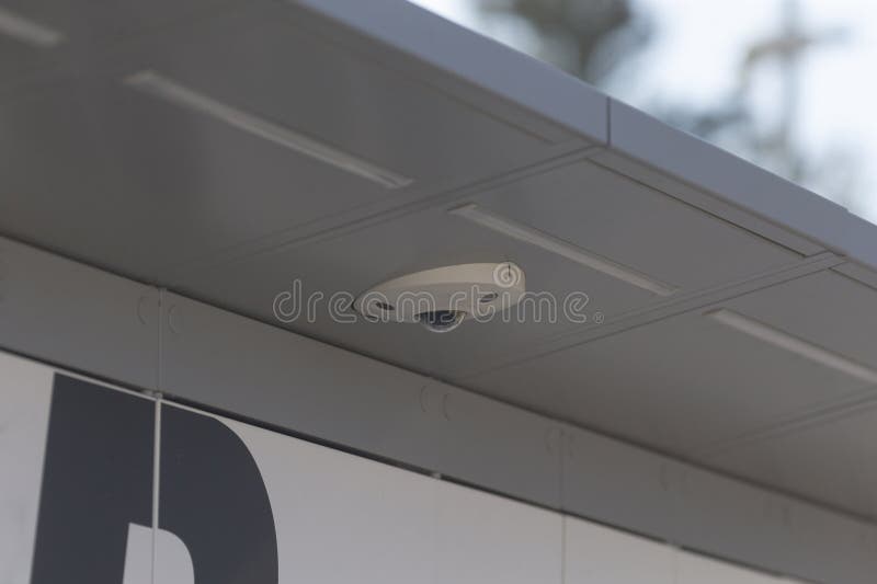 A Camera Has Been Securely Mounted on the Side of a Tall Building Stock ...