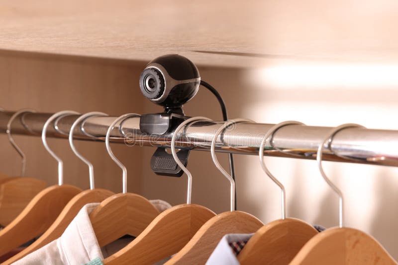 Camera Hidden between Hangers in Wardrobe Closet Stock Photo - Image of ...