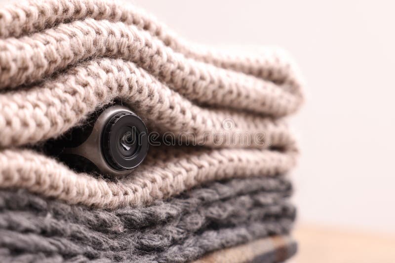 Camera Hidden Under Plaid on Blurred Background, Closeup. Space for ...