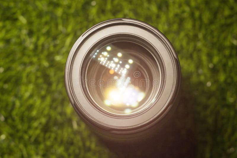 Camera lens on the grass stock image. Image of photographers - 240829997