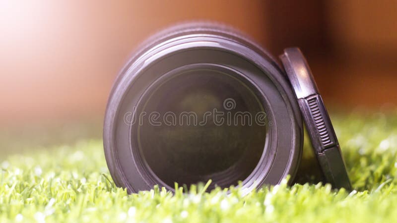 Camera lens on the grass stock photo. Image of frame - 240830360