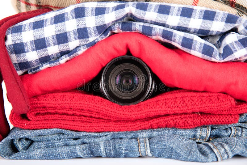Camera Lens in a Stack of Clothes Stock Image - Image of clothes ...