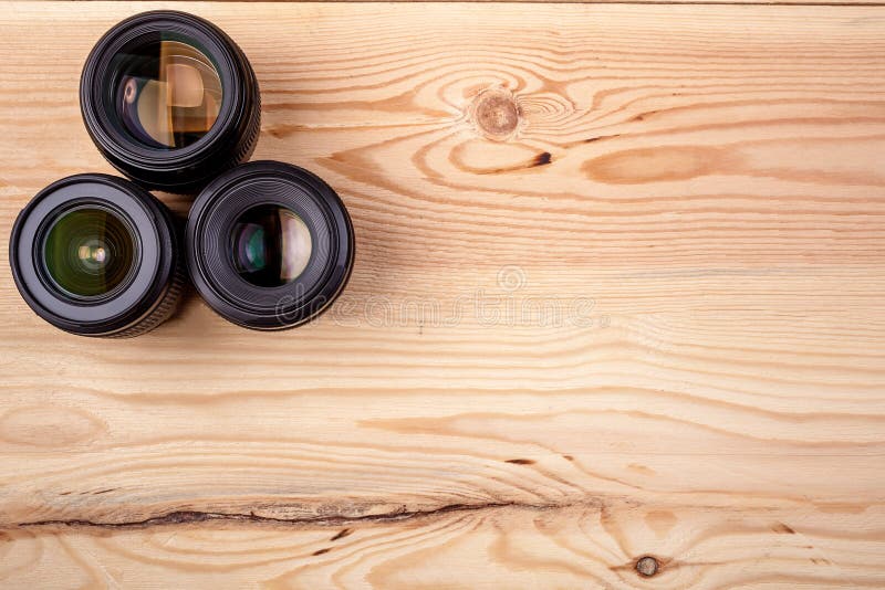 Camera Lenses on a Wooden Table Top View. Background and Workspace for ...