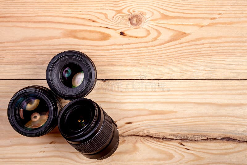 Camera Lenses on a Wooden Table Top View. Background and Workspace ...