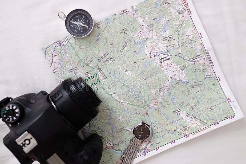 Camera, Magnetic Compass and Clock on the World Map. Adventure ...