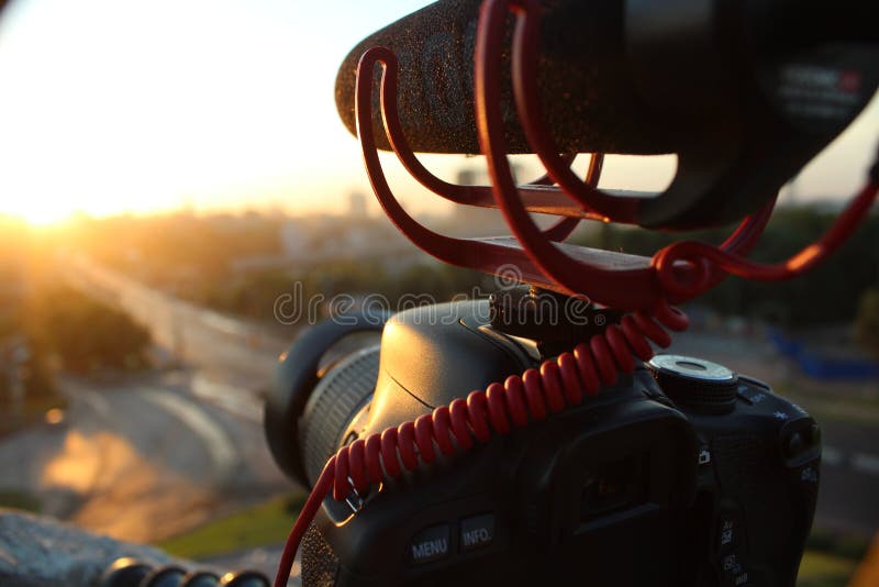 Camera with Microphone during Sunrise Above City Streets. Stock Photo ...