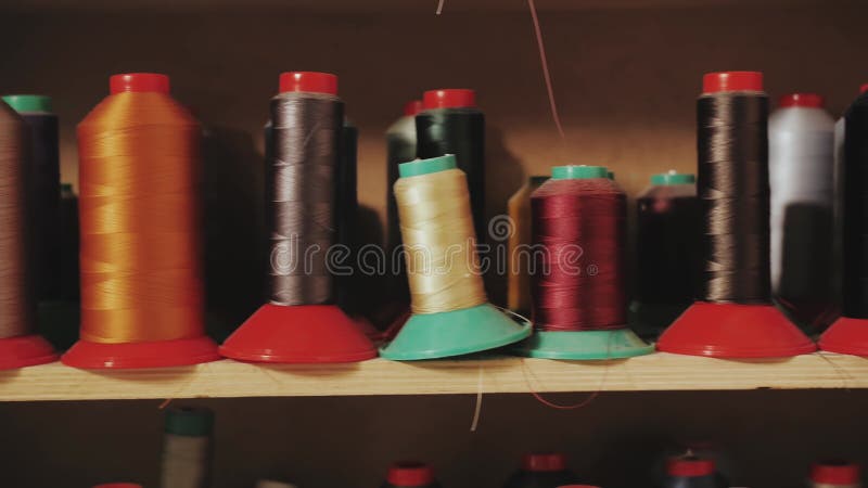The Camera Moves from Colorful Assorted Spools of Thread on Shelves in ...