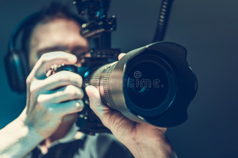 Camera Operator Captures Footage with Professional Equipment in a ...