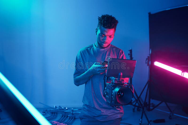 Camera Operator Using Gadgets during His Work Stock Photo - Image of ...