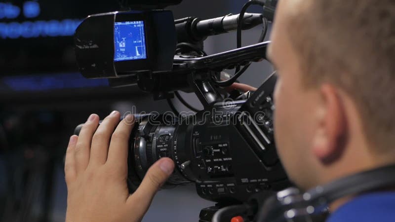 Camera Operator Working with a Cinema Broadcast TV Camera Stock Footage ...