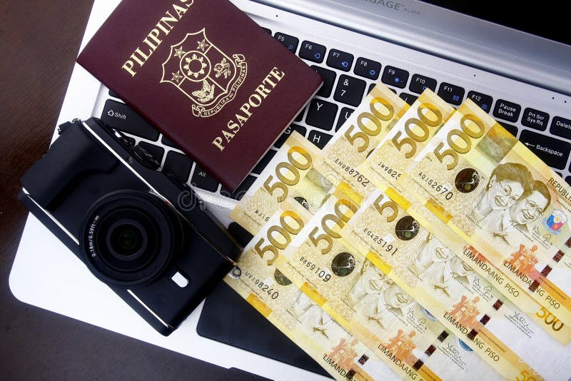 Camera, Passport and Philippine Peso Bills on a Laptop Computer. Stock ...