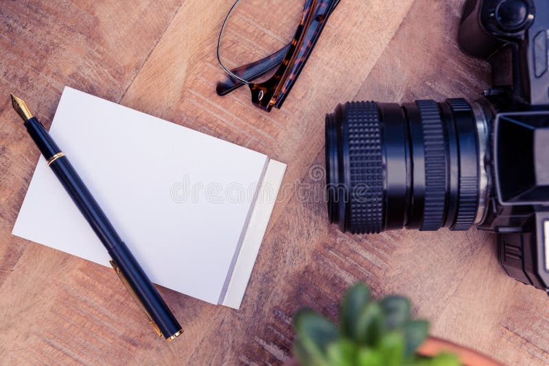 Pen on Paper by Camera and Eye Glasses at Table Stock Image - Image of ...