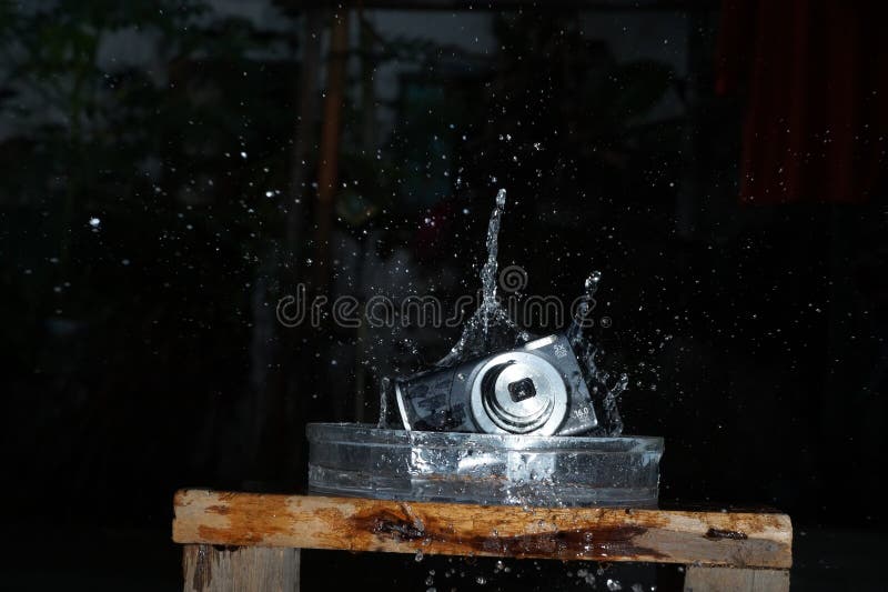 Camera splash with water stock image. Image of iron - 220887853