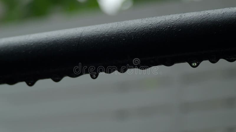 Camera Static through a Window on Raindrop Sticks on a Clothes Rack and ...