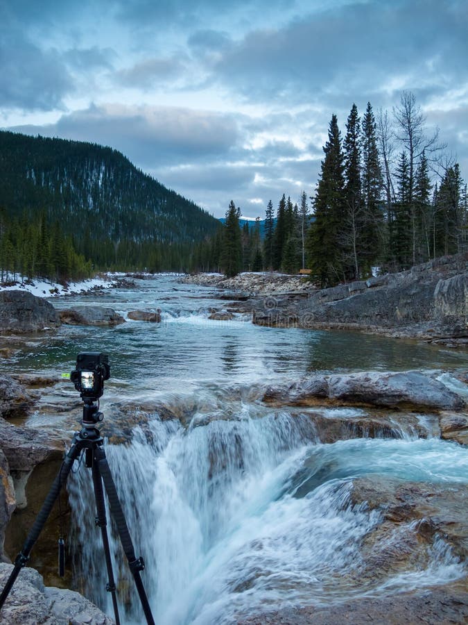 Camera on a Tripod Setup in Front of a Waterfall Stock Image - Image of ...