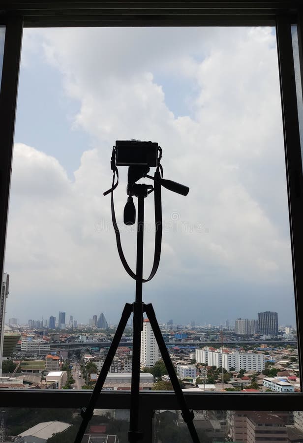 Camera with Tripod Shooting Photography Cityscape Outside the Window ...