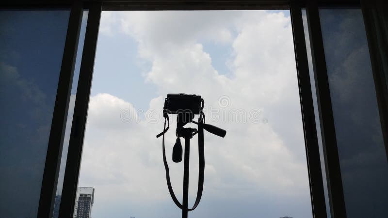 Camera with Tripod Shooting Photography Cityscape Outside the Window ...