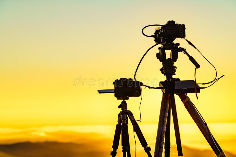 Camera on Tripod Take Photo from Sunset Above Clouds Stock Image ...