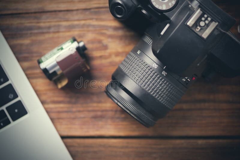 Camera on Wooden Table with Computer and Roll Stock Photo - Image of ...