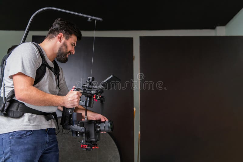 The Cameraman in the Studio Using a Professional Camera with a ...