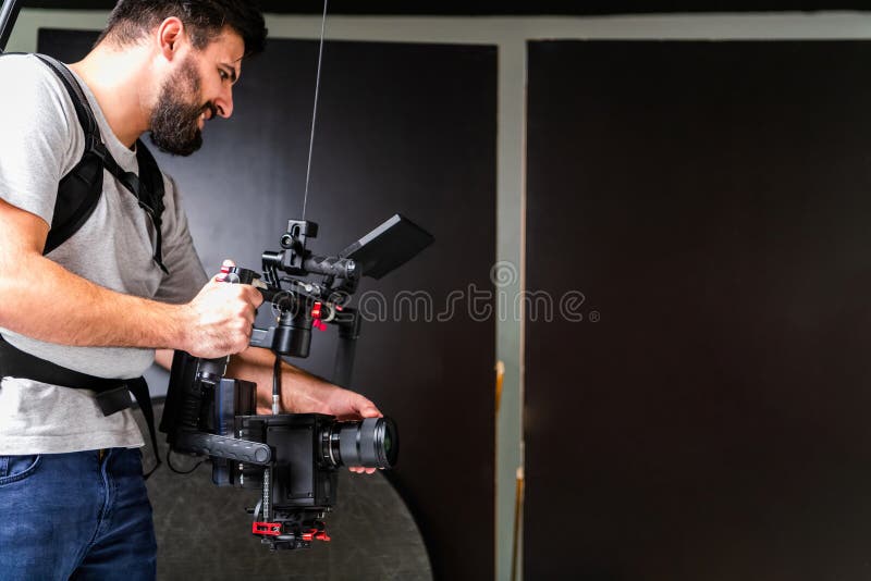 The Cameraman in the Studio Using a Professional Camera with a ...