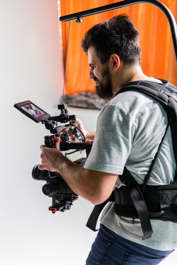 The Cameraman in the Studio Using a Professional Camera with a ...