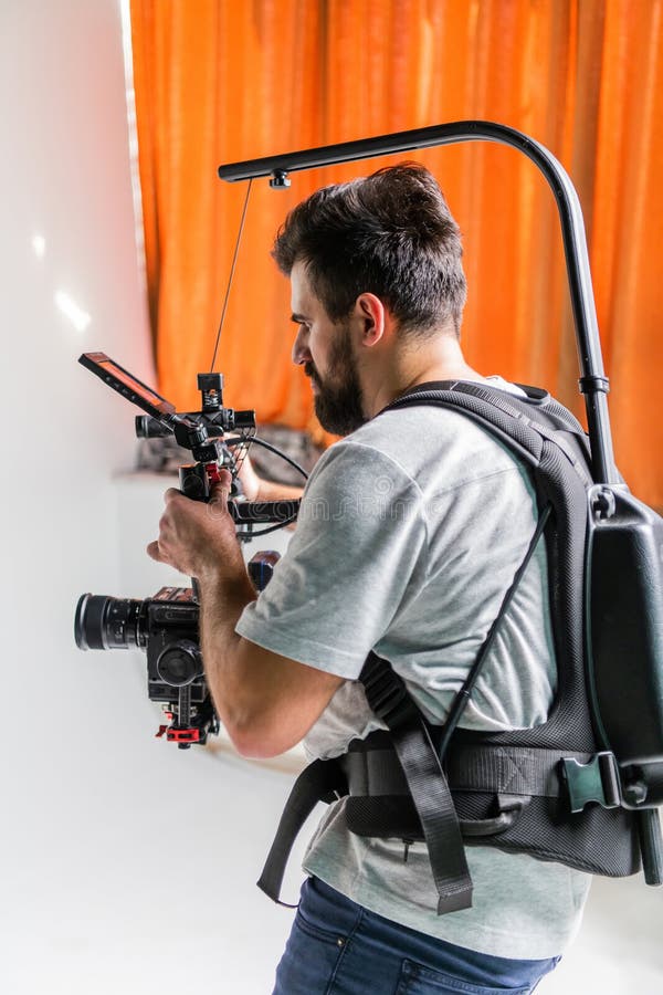 The Cameraman in the Studio Using a Professional Camera with a ...