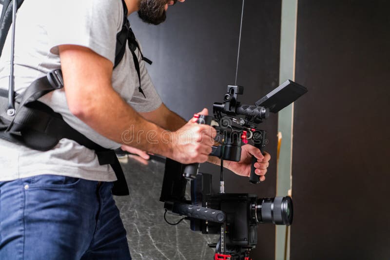 The Cameraman in the Studio Using a Professional Camera with a ...