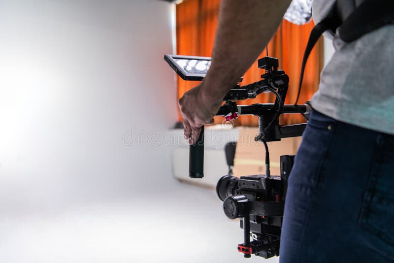 The Cameraman in the Studio Using a Professional Camera with a ...